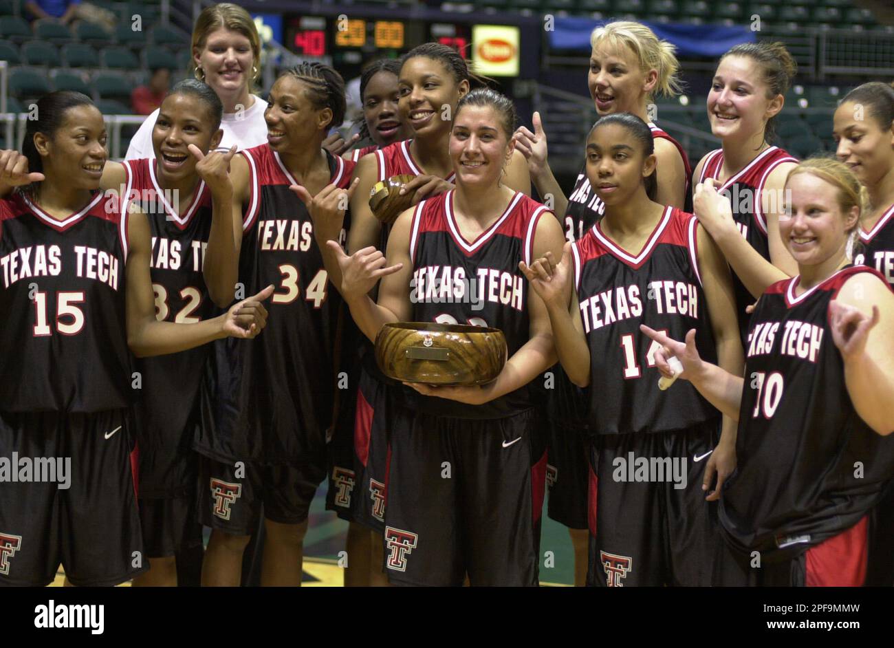 Texas Tech players give the Hawaiian "shaka" sign while posing with the ...