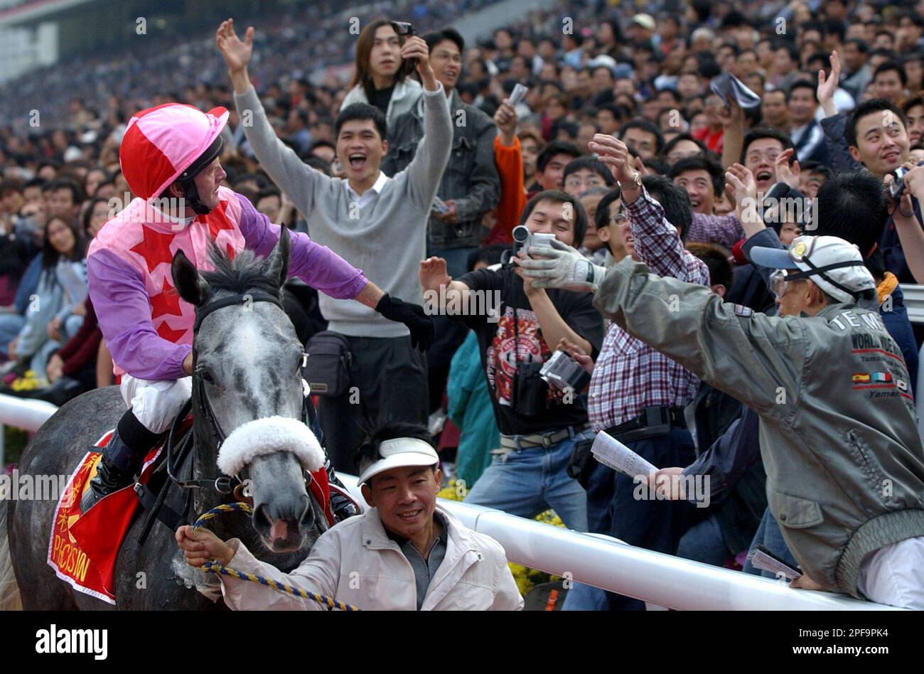 Irish jockey Michael Kinane celebrates with punters after riding Hong ...