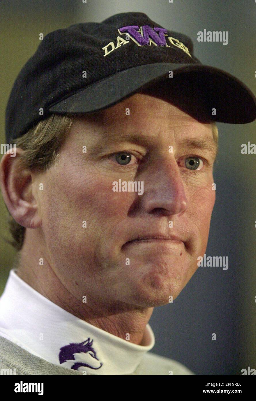 Washington football coach Rick Neuheisel speaks briefly with the media ...