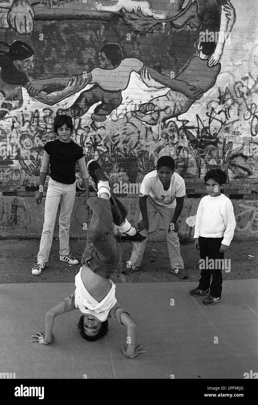 ** ADVANCE FOR MONDAY, DEC. 16 **Children watch as another break dances ...