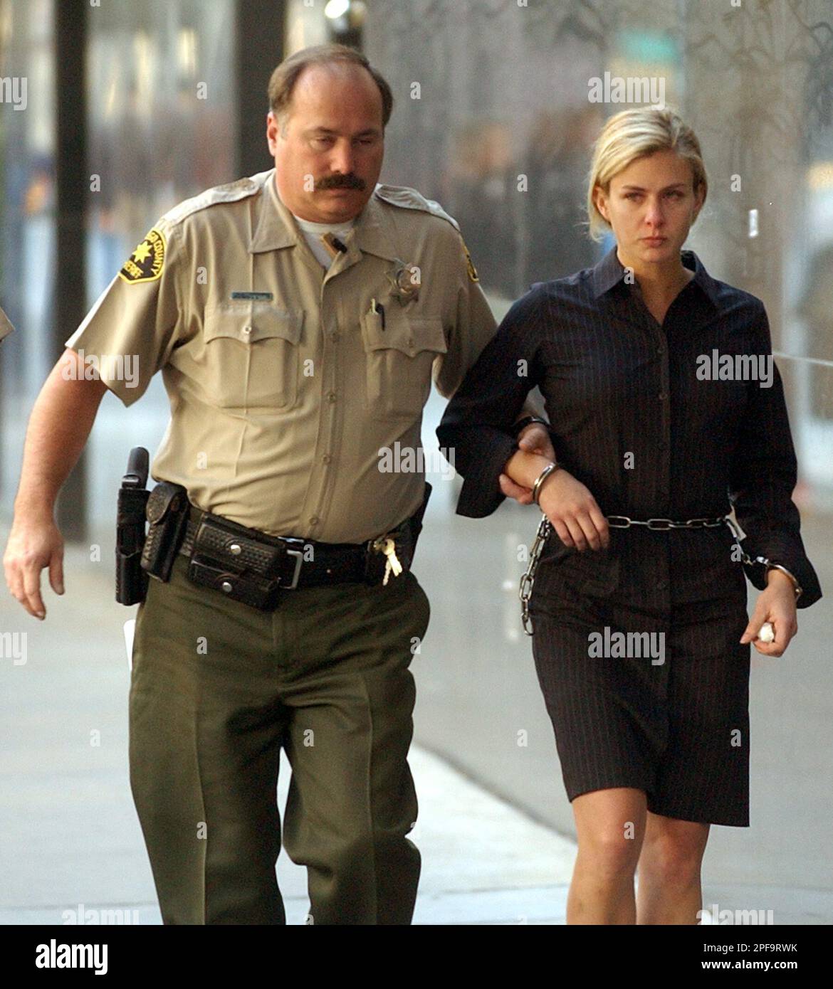 A sheriff's deputy, left, escorts convicted murderer Kristin Rossum ...