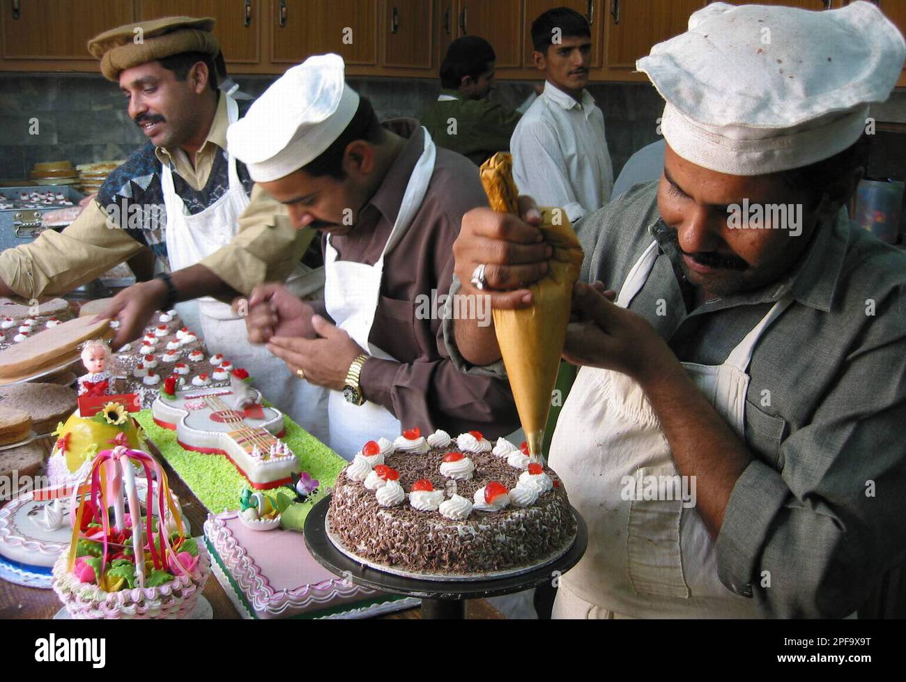 Bakery workers prepare cakes at their shop in Multan, Pakistan, for Eid-ul Fitr, a celebration ...