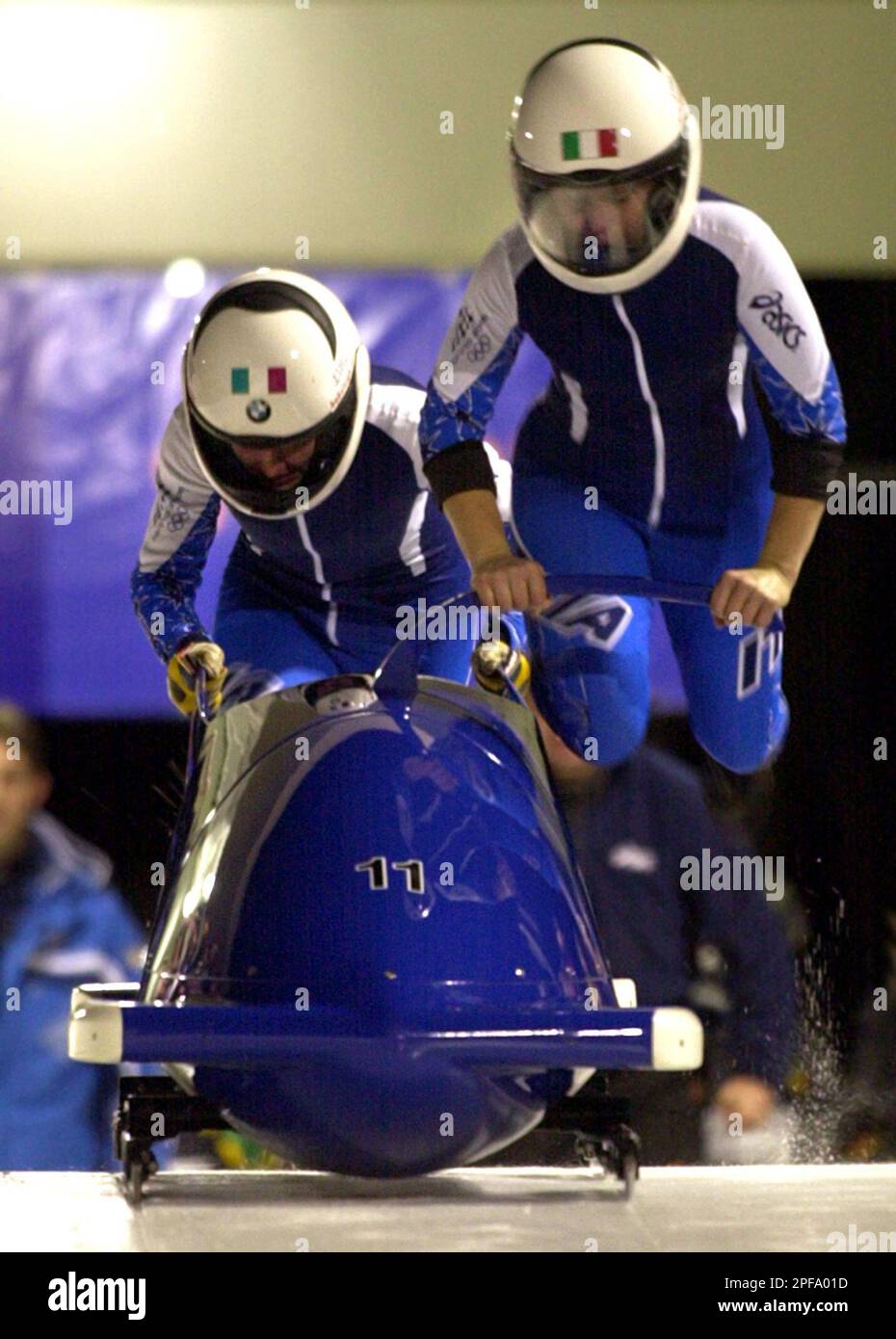 Italy's Gerd Weissensteiner jumps into the sled as she and Jennifer ...