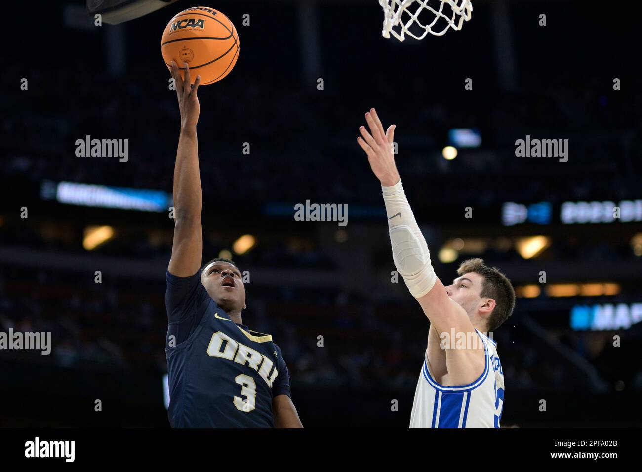 Oral Roberts guard Max Abmas (3) shoots in front of Duke center Kyle Filipowski, right, during ...