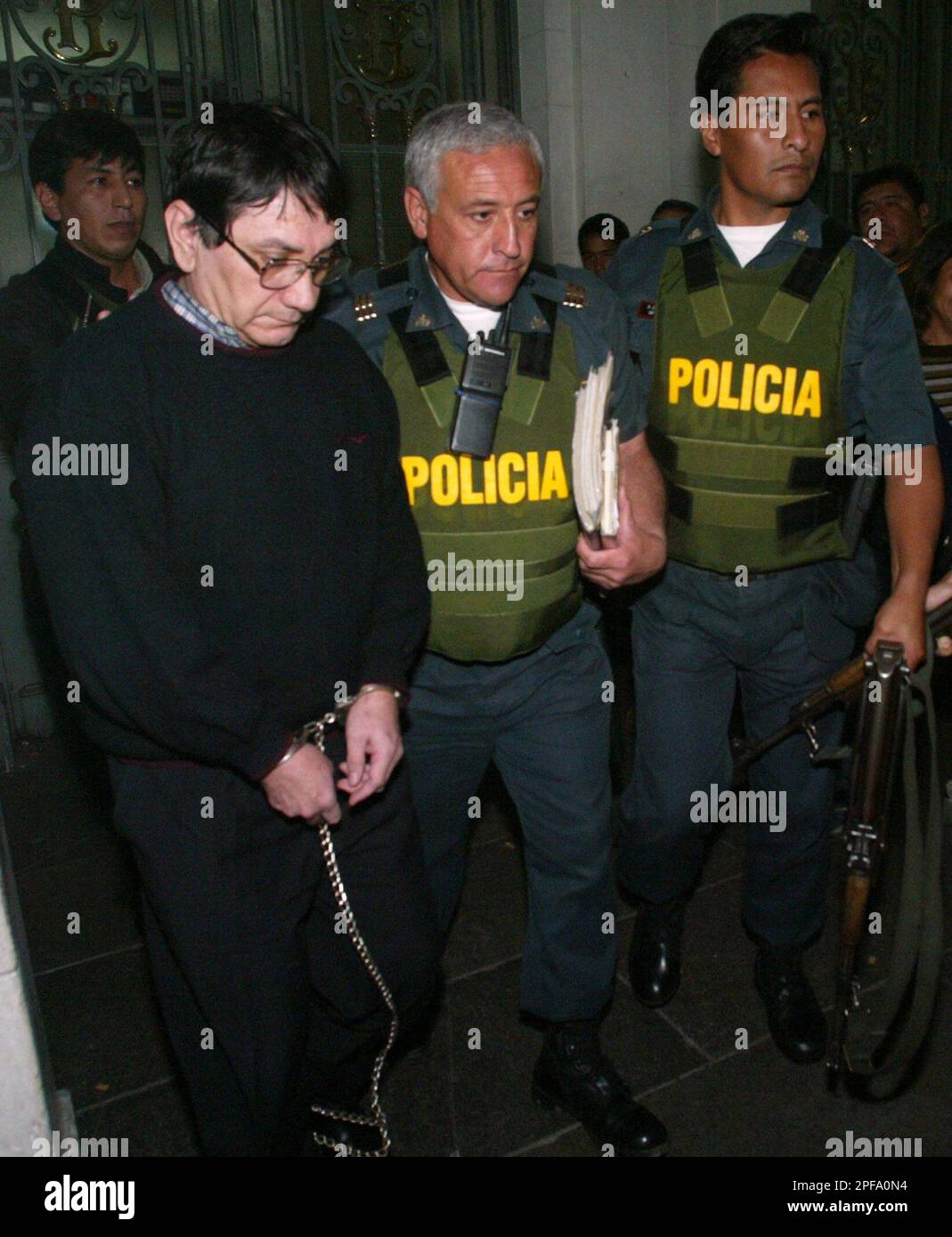 Peruvian police escort retired army Maj. Santiago Martin Rivas, left ...