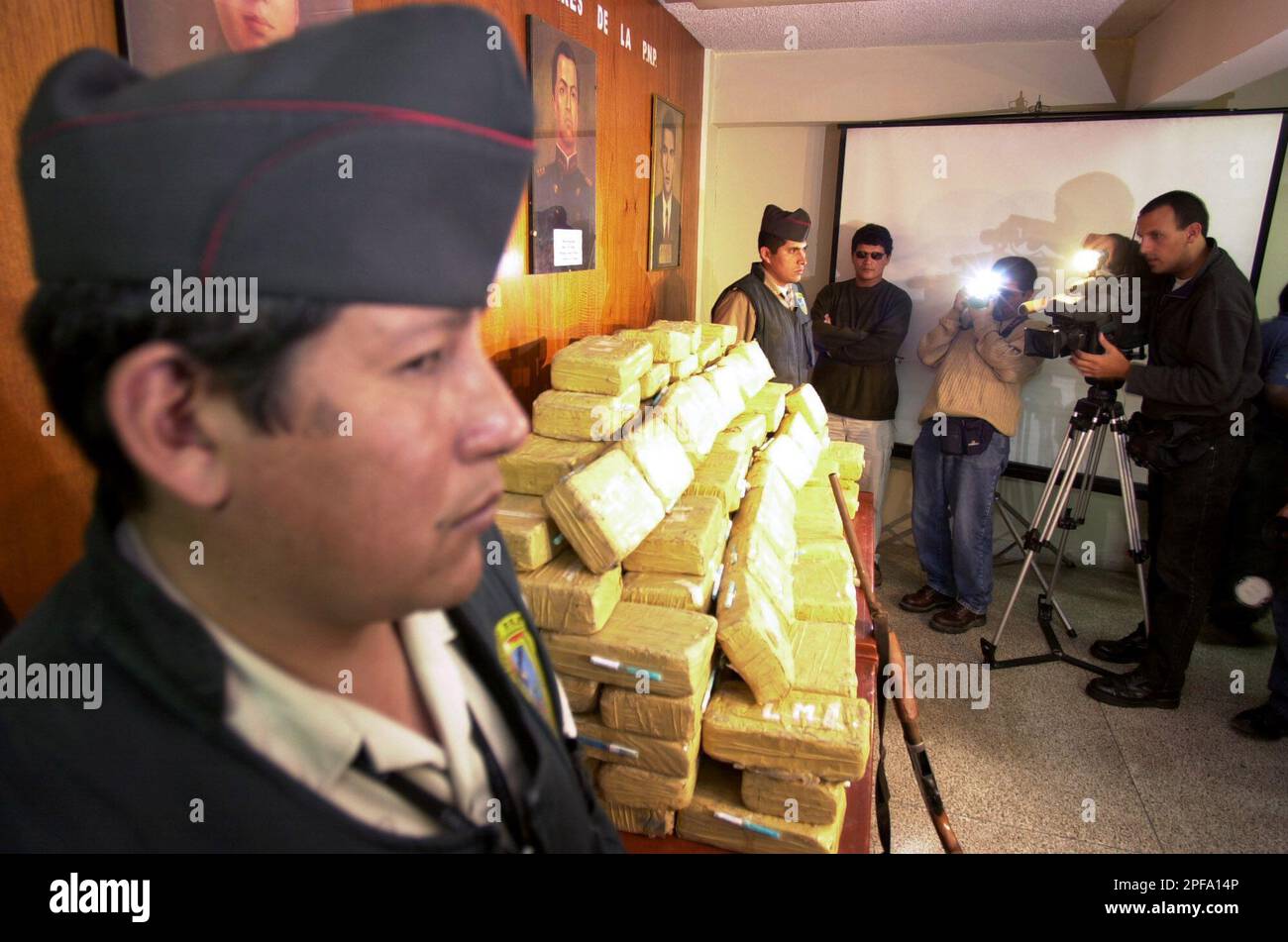 A Peruvian police officer guards 335 kilograms (738 lbs) of cocaine at ...