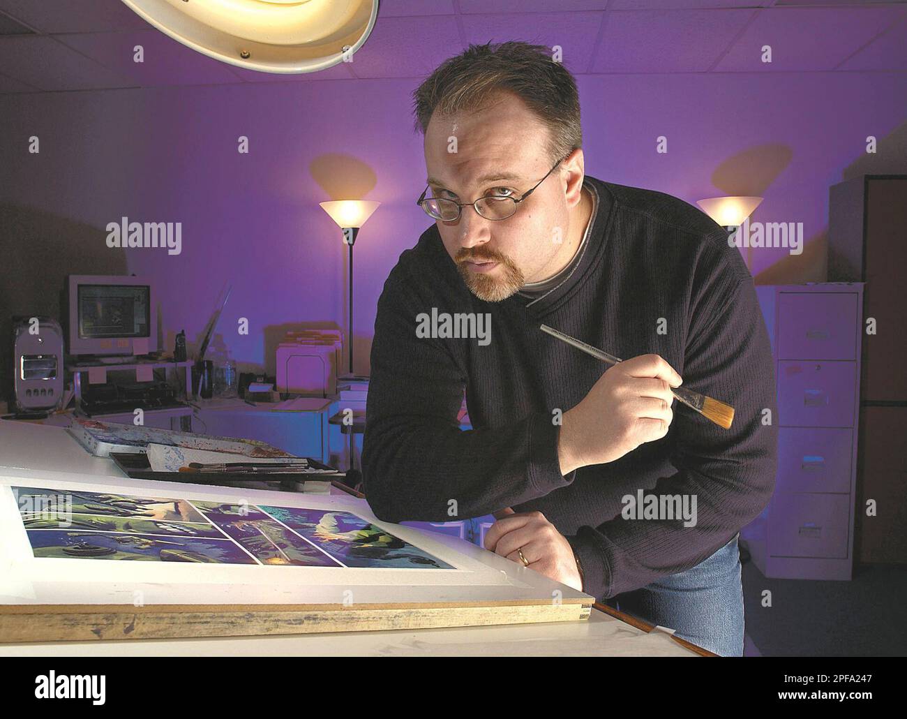 Brian Ashmore, the illustrator of the new Batman book, "Batman: Absolution," works on some of ...