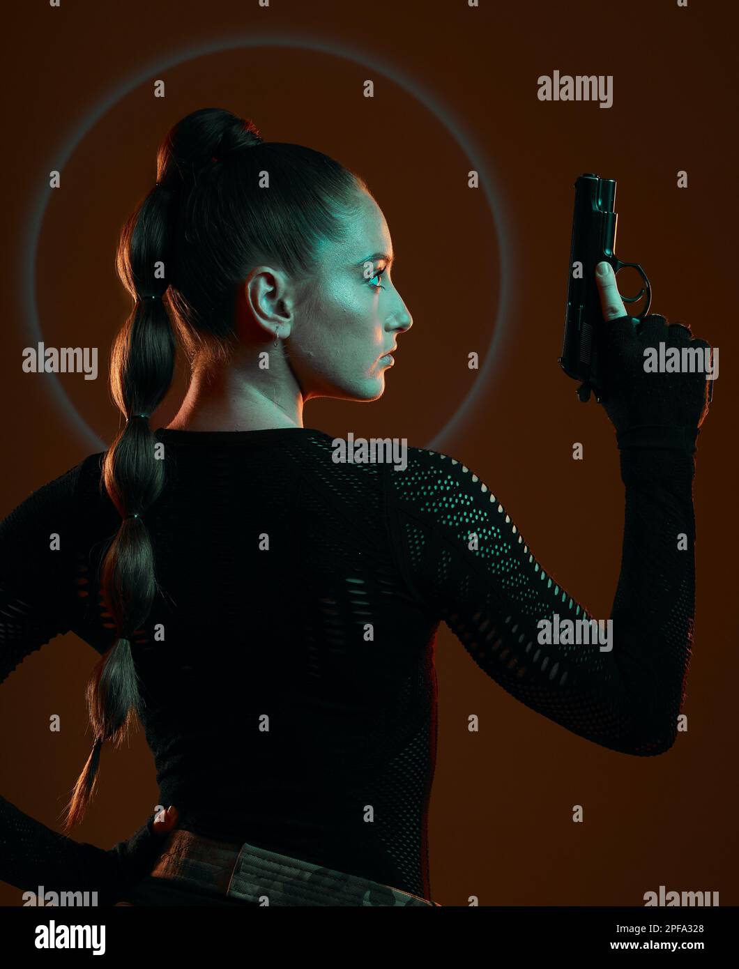 Dark, assassin and a woman with a gun for action isolated on a studio ...