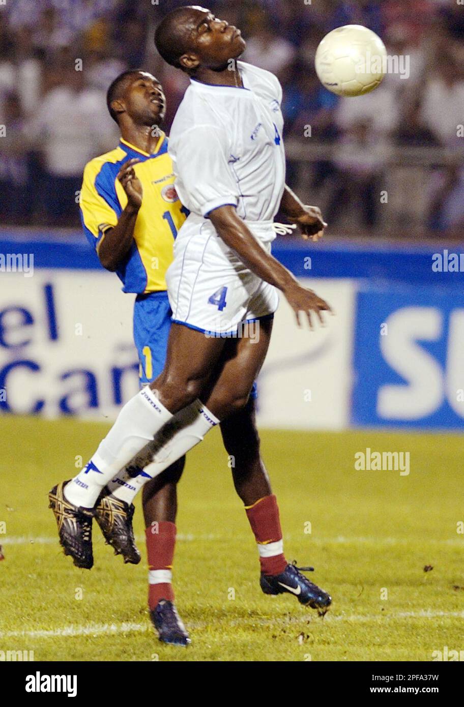 Samuel Caballero (4) of Honduras heads the ball with Colombiam Elkin ...