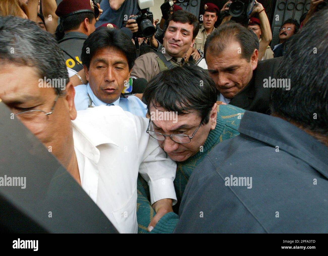 Police arrest retired army Maj. Santiago Martin Rivas, center with ...