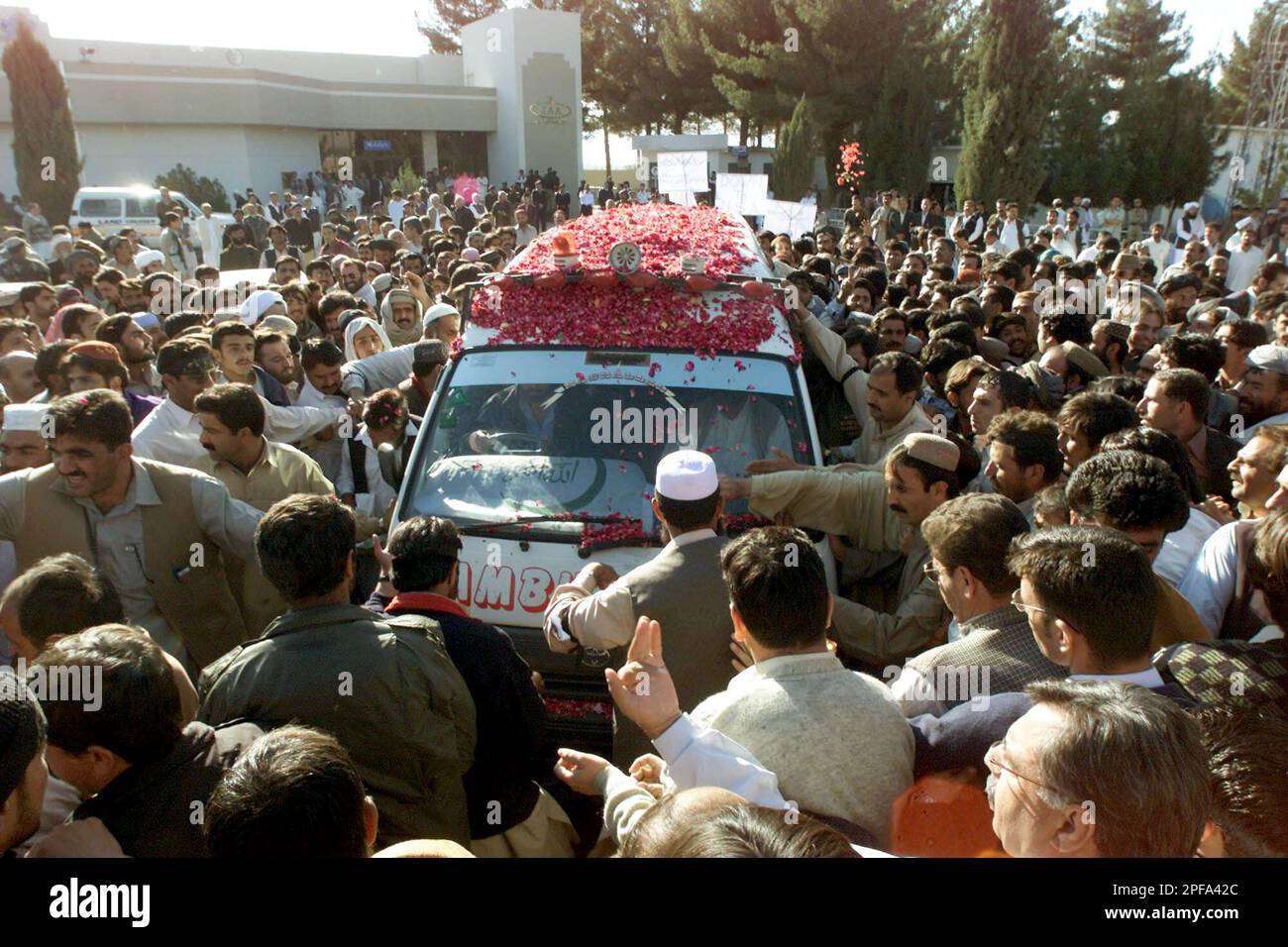 People gathered around an ambulance carrying Aimal Kasi's dead body at ...