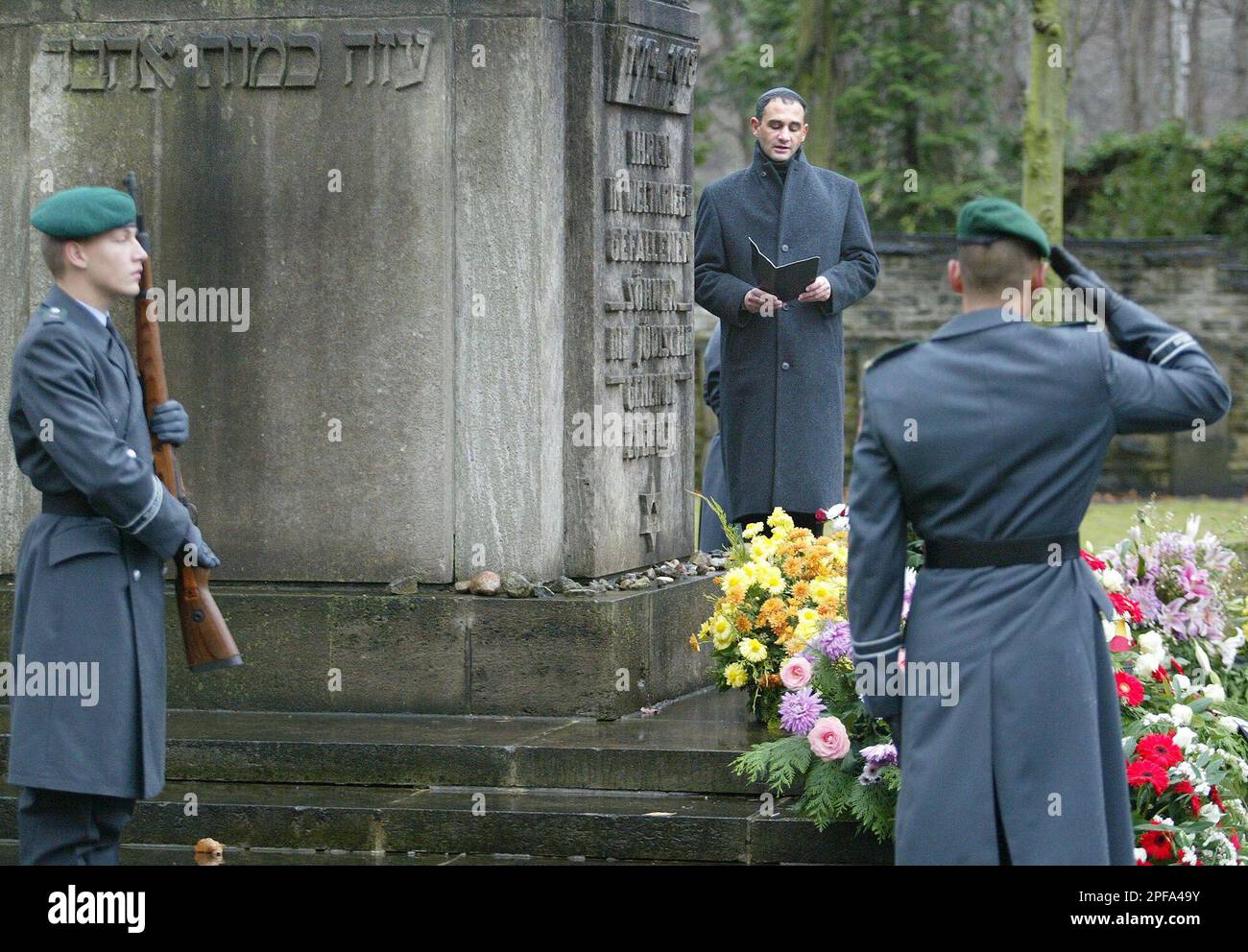 A German soldier salutes as Simon Zkorenblut, center, reads a prayer on ...