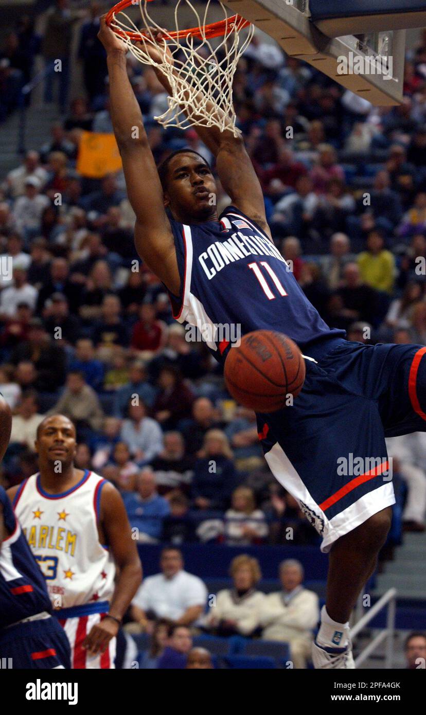 Connecticut's Hilton Armstrong, right, dunks as Harlem's Cedric ...
