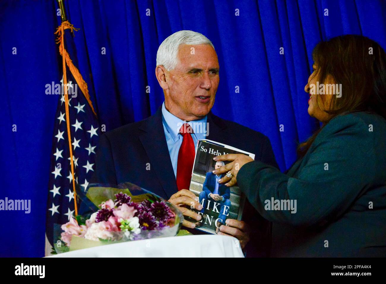 Former Vice President Mike Pence signs copies of his book at a dinner ...
