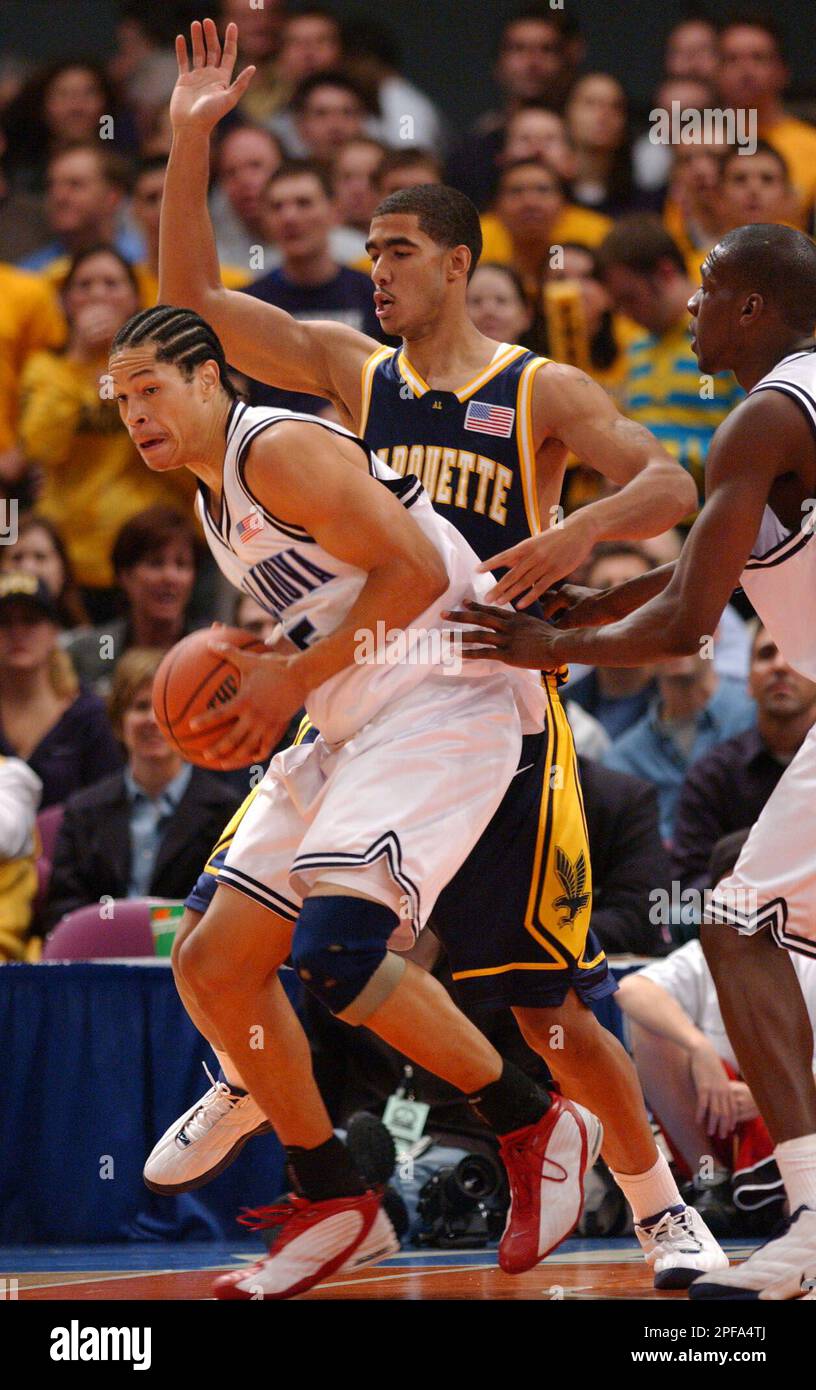 Villanova's Ricky Wright drives to the hoop as Marquette's Scott ...