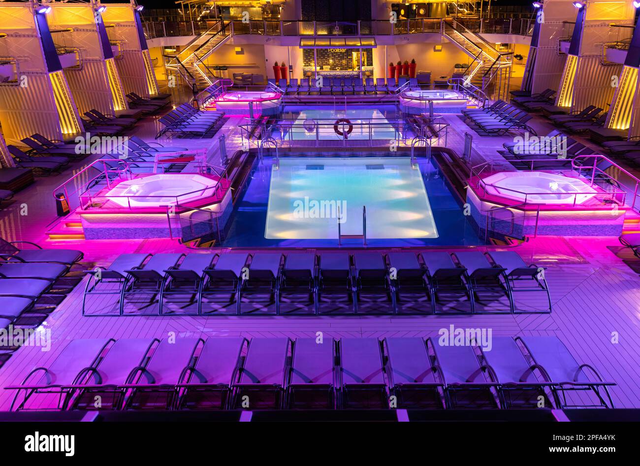 Cruise ship luxury swimming pool at night on top deck with scenic views ...