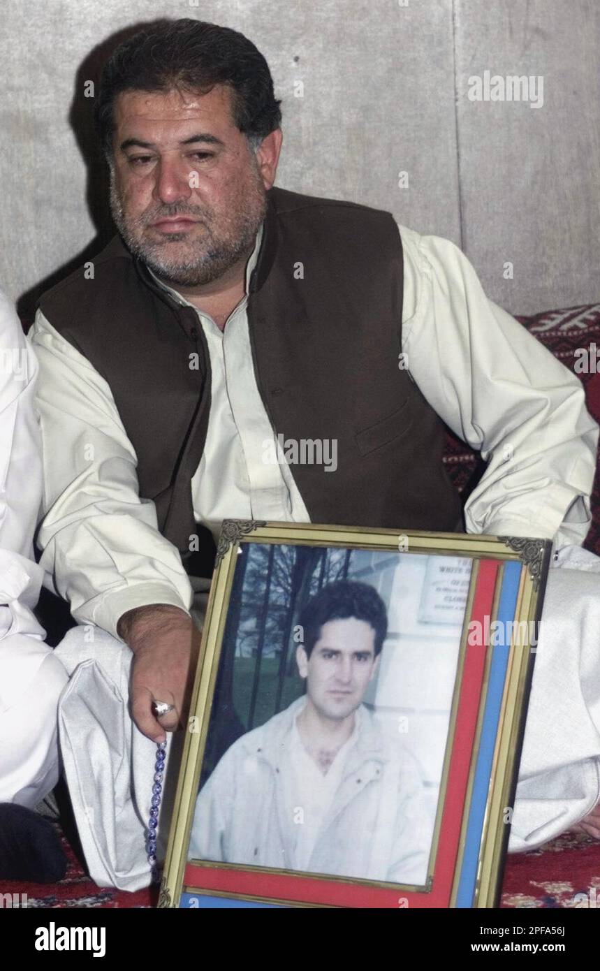 Nasibullah Khan Kasi, brother of Aimal Kasi, sits with his brother ...