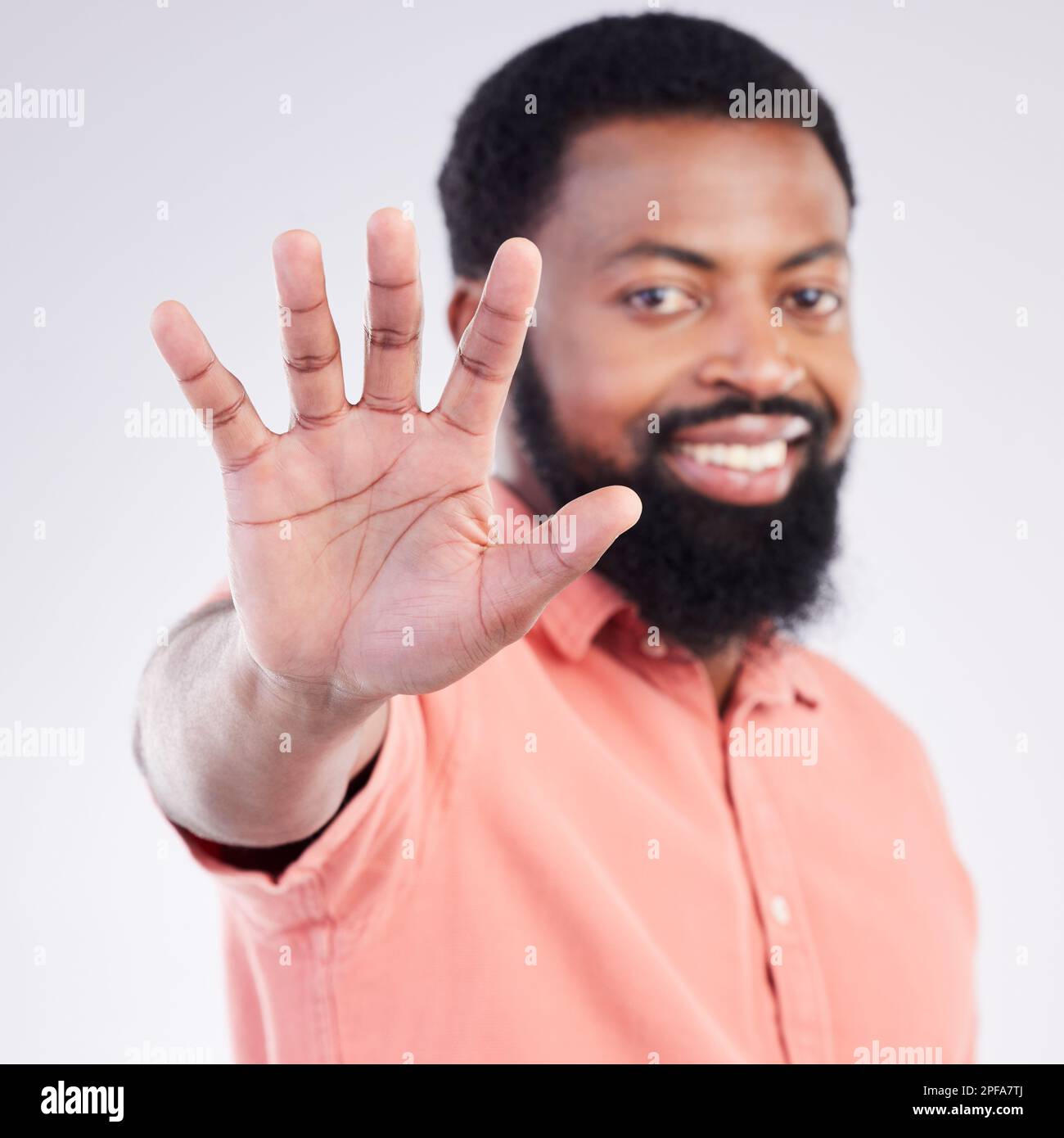 Black man, hand sign and stop in studio portrait with smile, icon and ...