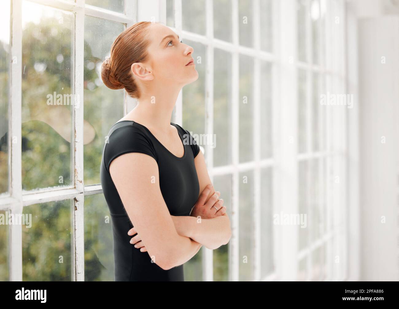 Waiting on some sign. a ballet dancer standing alone looking nervous ...