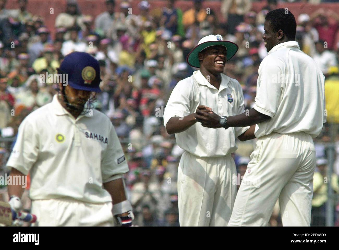 West Indies' Cameron Cuffy, right, with Cris Gayle, center, celebrate ...