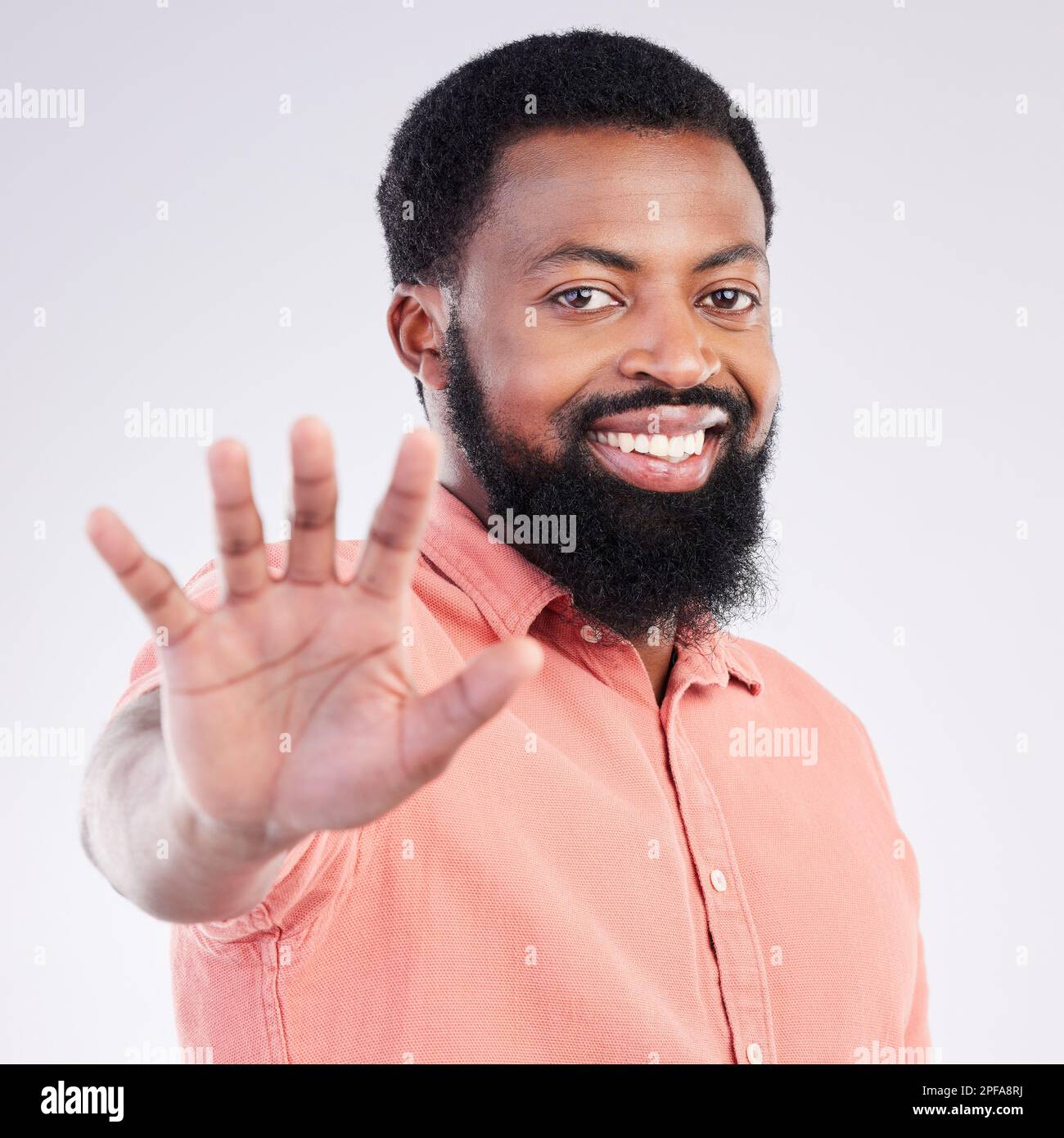 Black man, hand and stop in studio portrait with smile, sign language ...