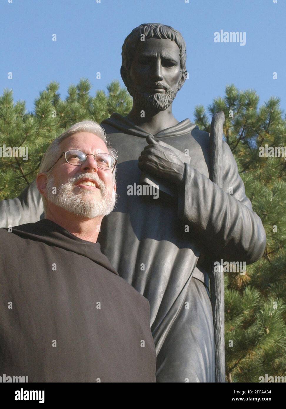 The Rev. Daniel Homan looks into the horizon as a statue of St ...