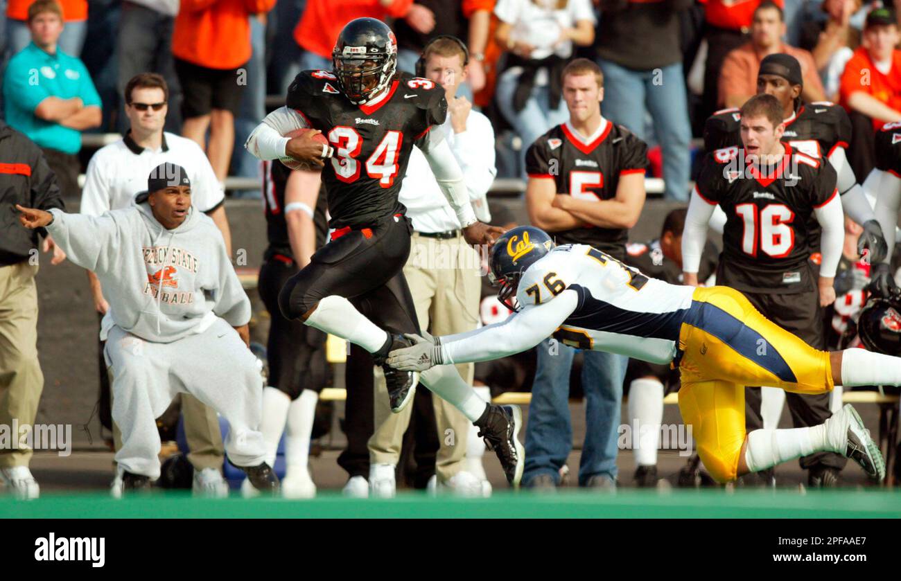 Oregon State's Steven Jackson, left, eludes the grasp of California's ...