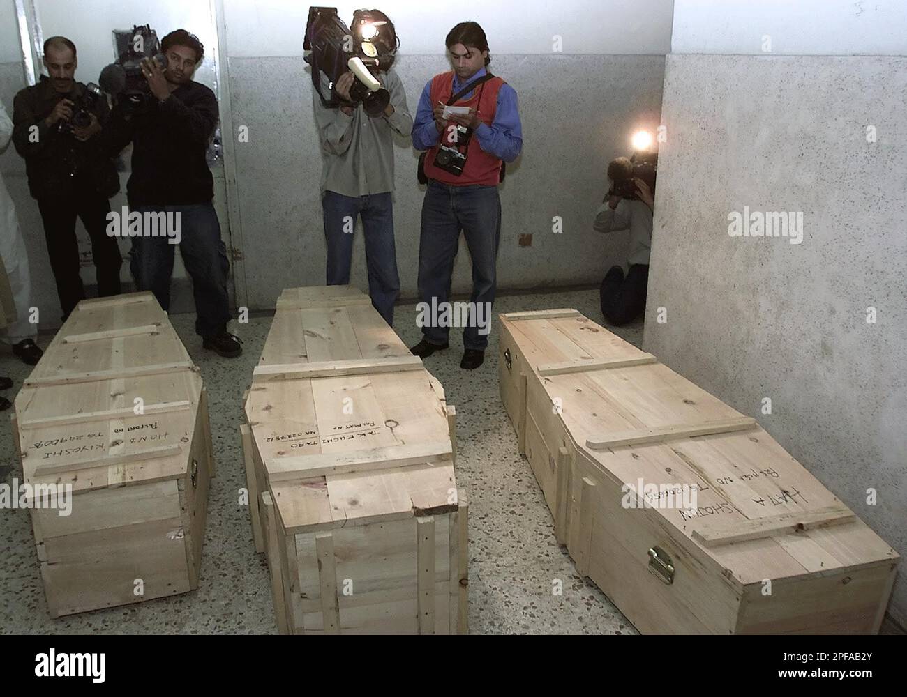 Dead bodies of three members of a Japanese television crew in coffins ...