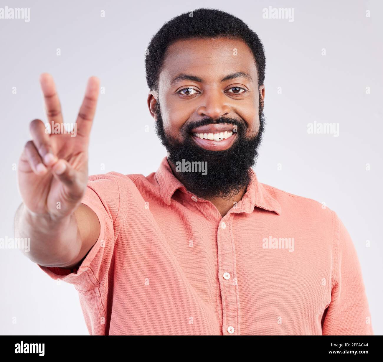 Black man, hand and peace sign in studio portrait with smile, emoji or ...