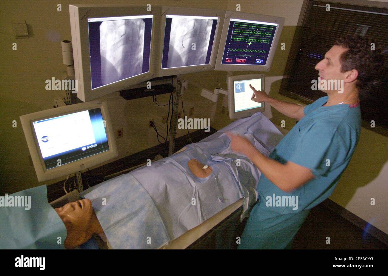 Dr. Mark Reisman points out the features of a medical simulator system ...