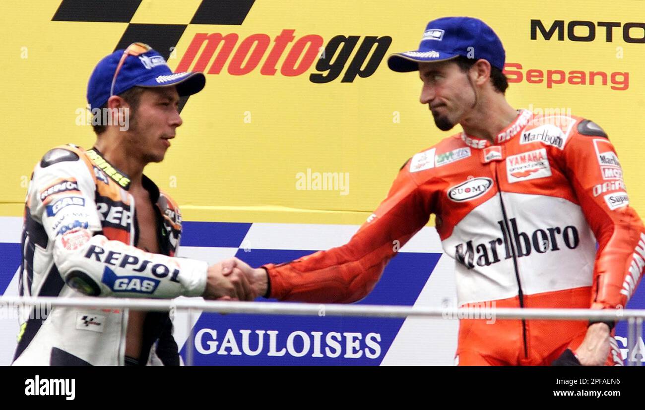 Italian Valentino Rossi of Repsol Honda, left, congratulates his ...