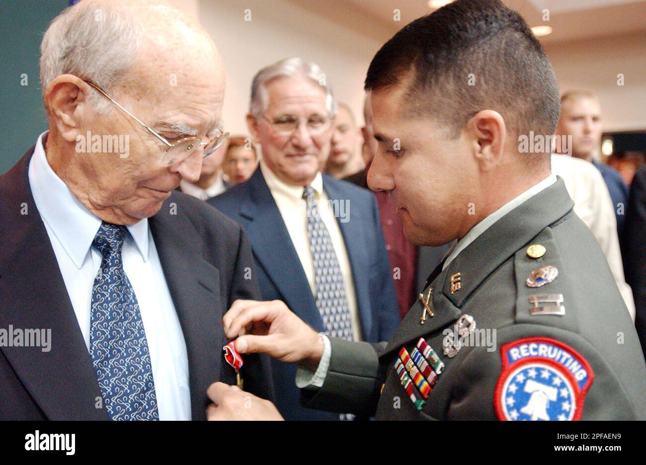 Army Capt. Troy J. Ramirez , right, presents Fred Fullerton Jr. with ...