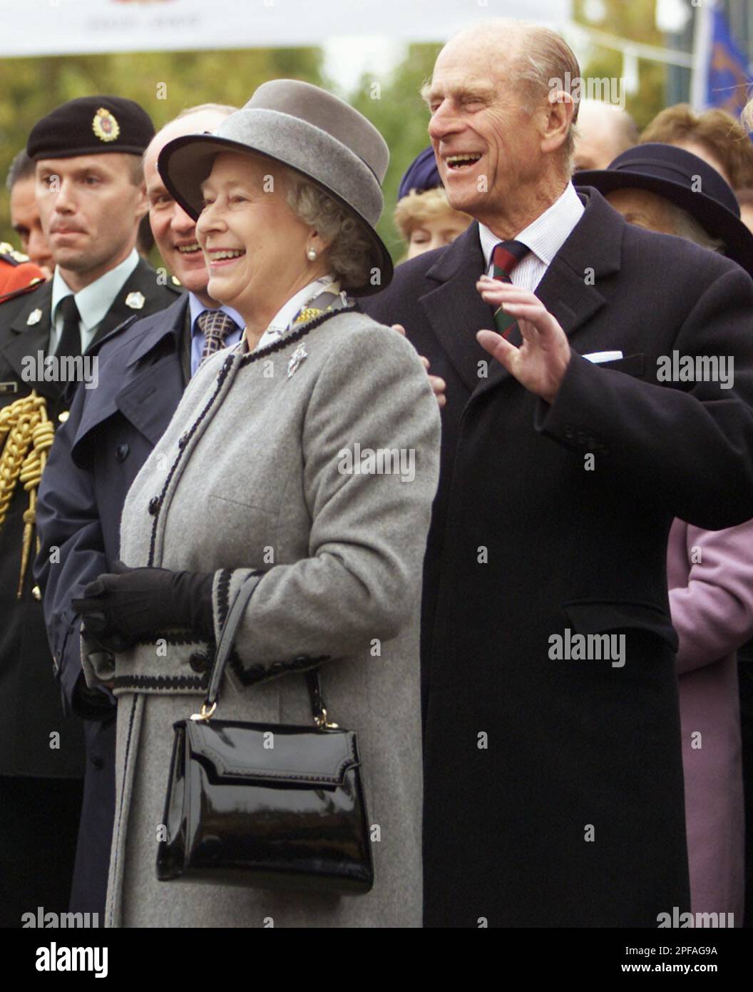 Queen Elizabeth II and the Duke of Edinburgh react as they watch a ...
