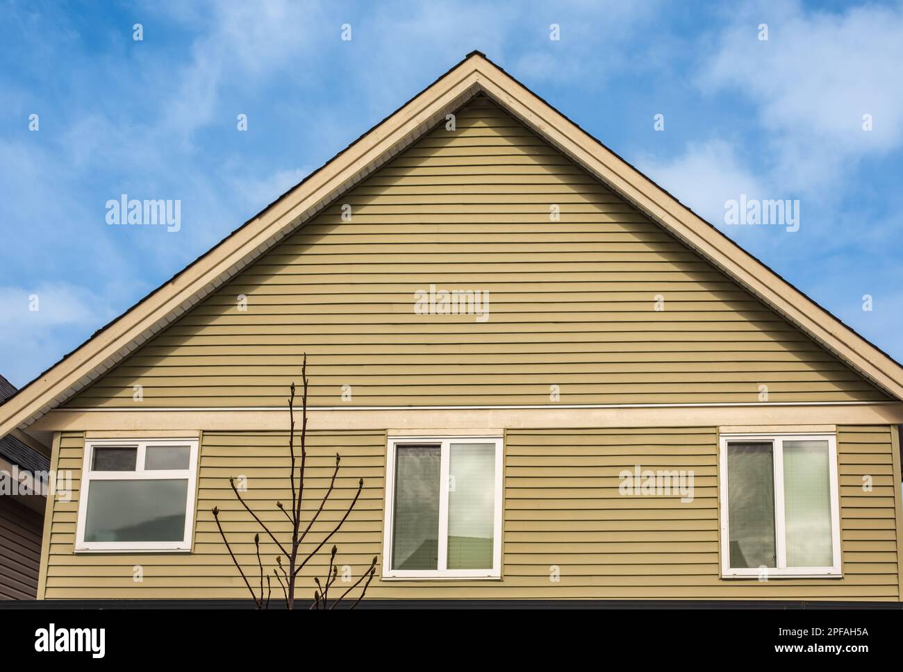 Top of a house with nice windows in the blue sky background. Beautiful ...