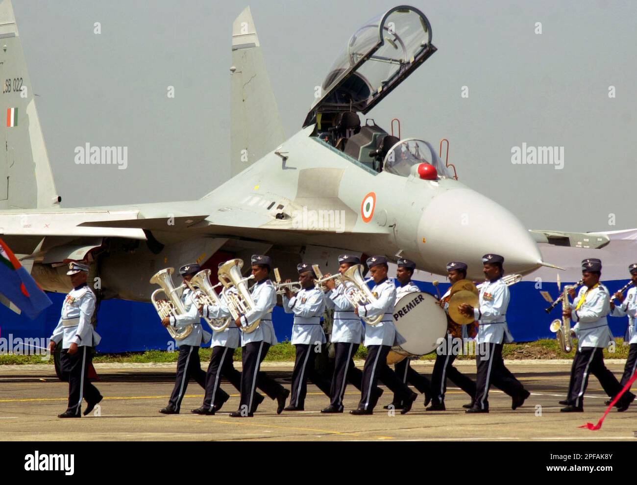 An air force band plays on in front of the Russian-made fighter jet ...