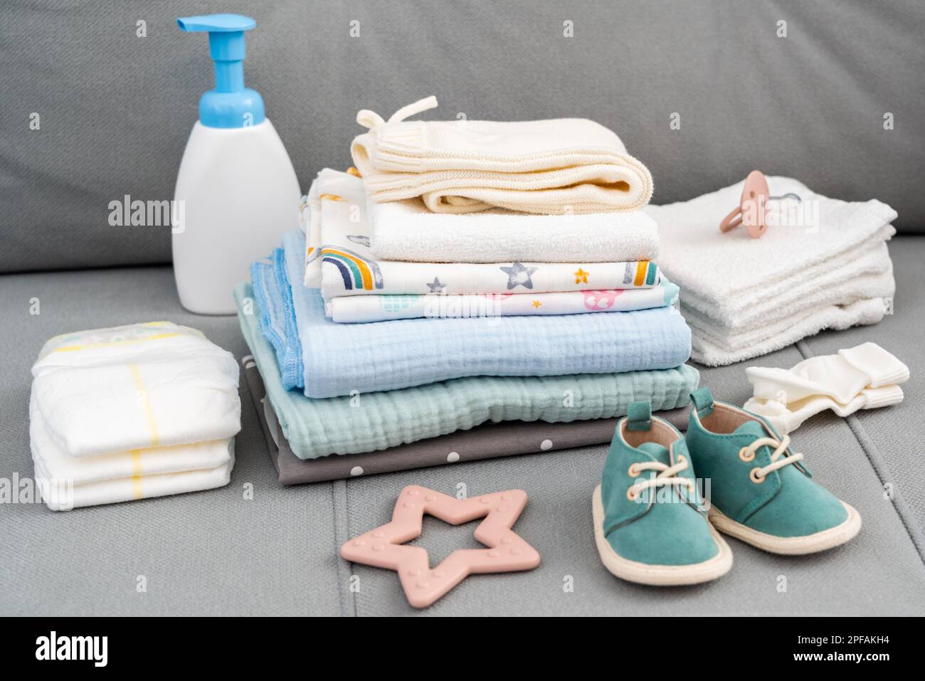 Set of diapers and kids stuff for little baby on a couch. Newborn baby ...