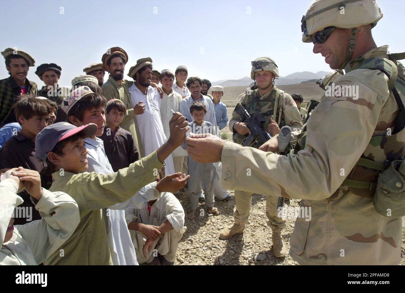 A U.S. Army soldier of Task Force Panther 82nd Airborne Division gives ...