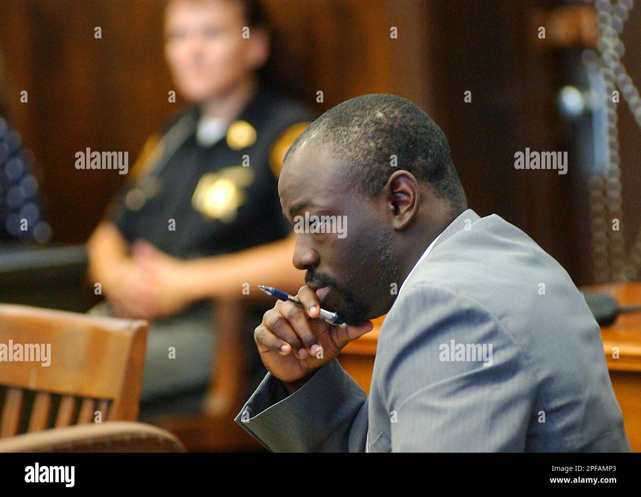 Defendant Gregory McKnight listens to potential jurors being ...