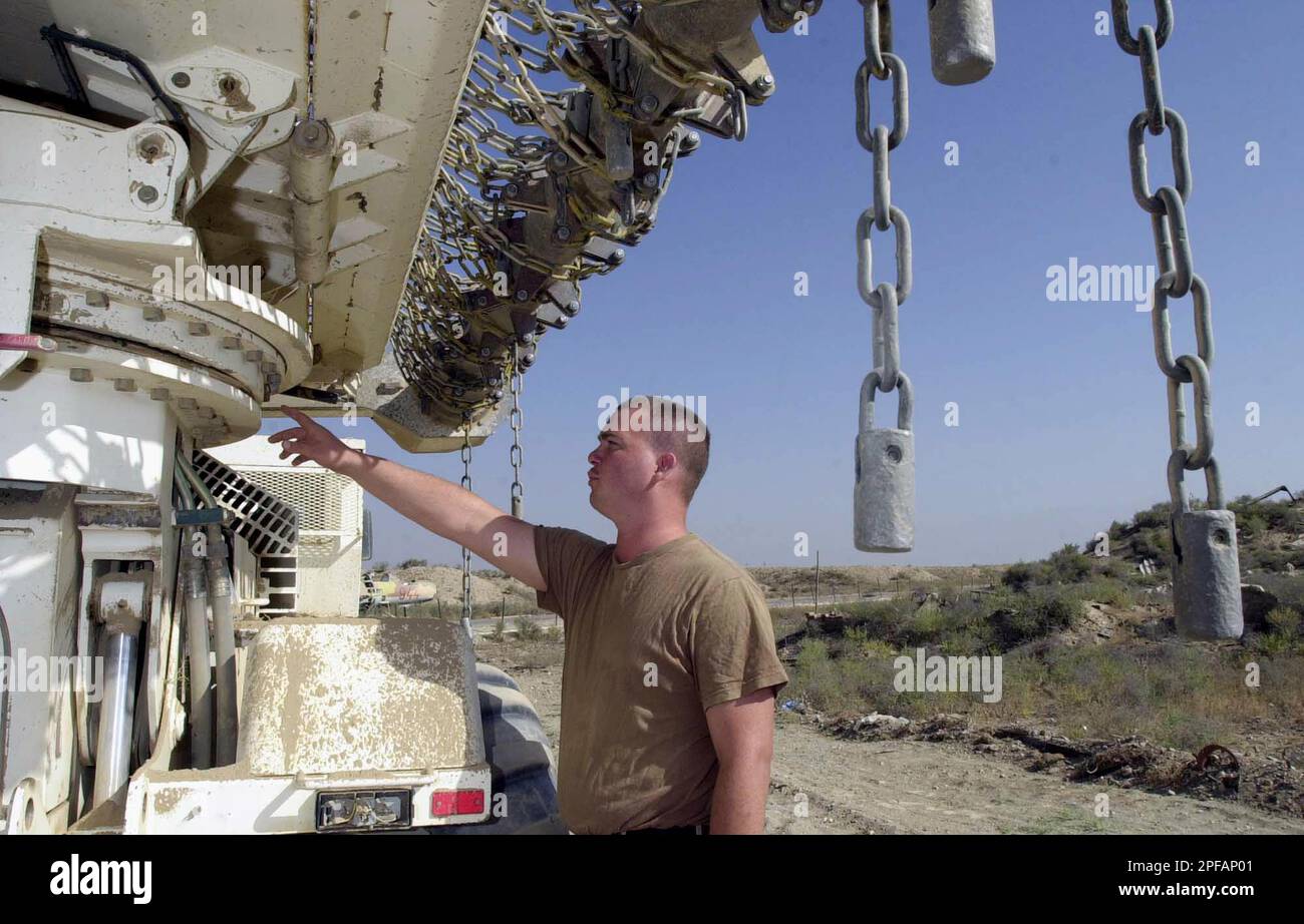 U.S. Army Specialist David Paulk, 24, Vick, La., makes checks on his ...