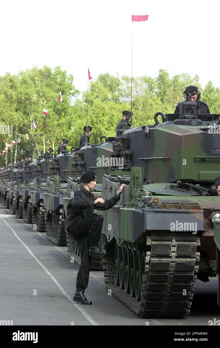 A Polish soldier gets into his Leopard tank that Poland's army received ...