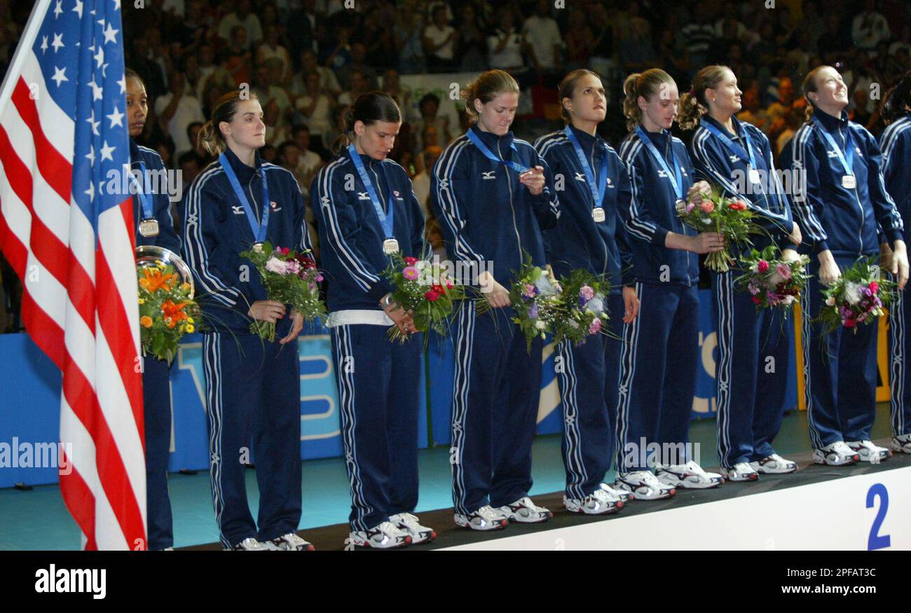 The U.S. volleyball team displays their silver medals during the ...