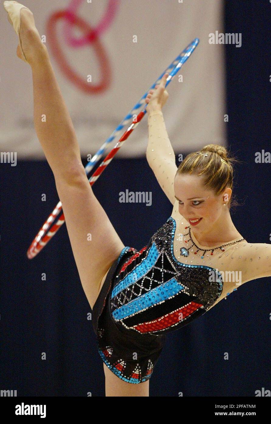 Mary Sanders of Canada strikes out a pose with a hoop in the first ...