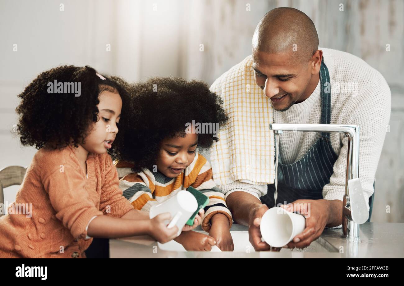 Happy, cleaning and father with children in kitchen for bonding ...