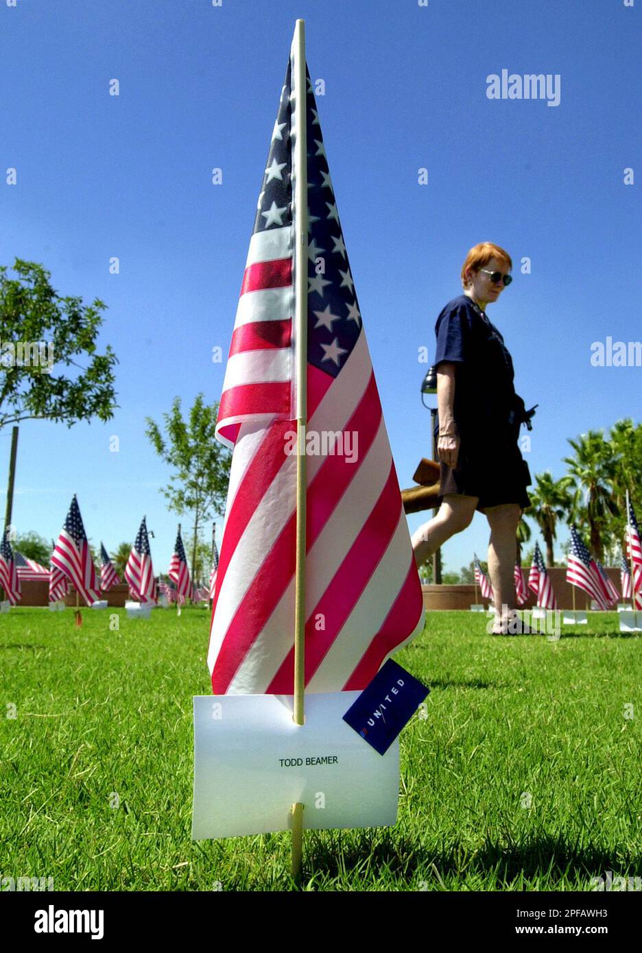 Lezlie Walser-Coles walks past a flag honoring Sept. 11 United Airlines ...