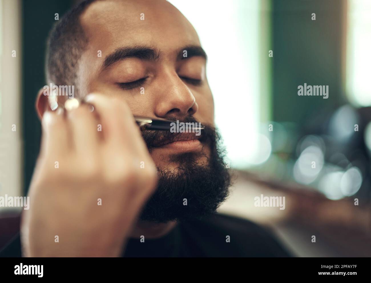 Lets pick this up off your lip. a handsome young man sitting and ...