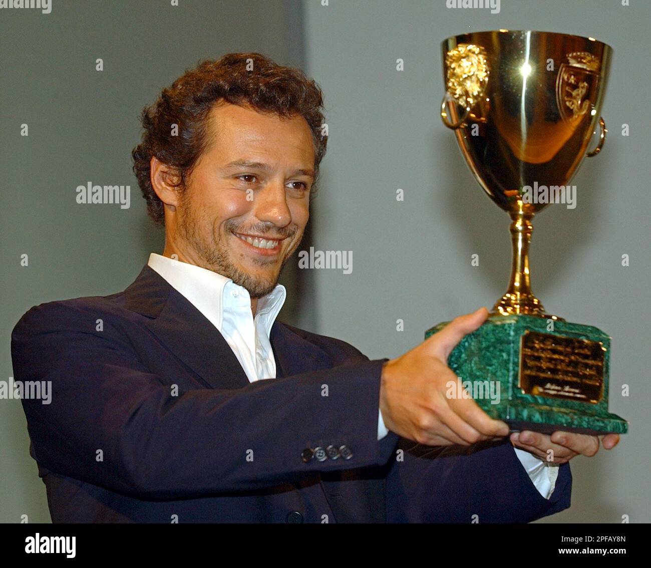 Italian actor Stefano Accorsi shows the "Volpi Cup" prize for best ...