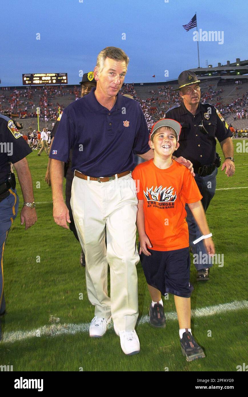 Auburn coach Tommy Tuberville and his son Tucker walk off the field ...