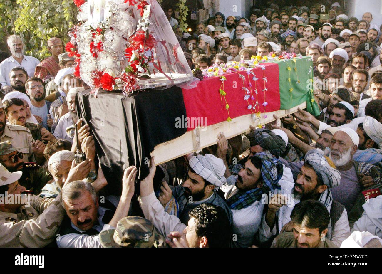 The coffin of Azimullah Khaksar draped in the Afghan flag is carried ...