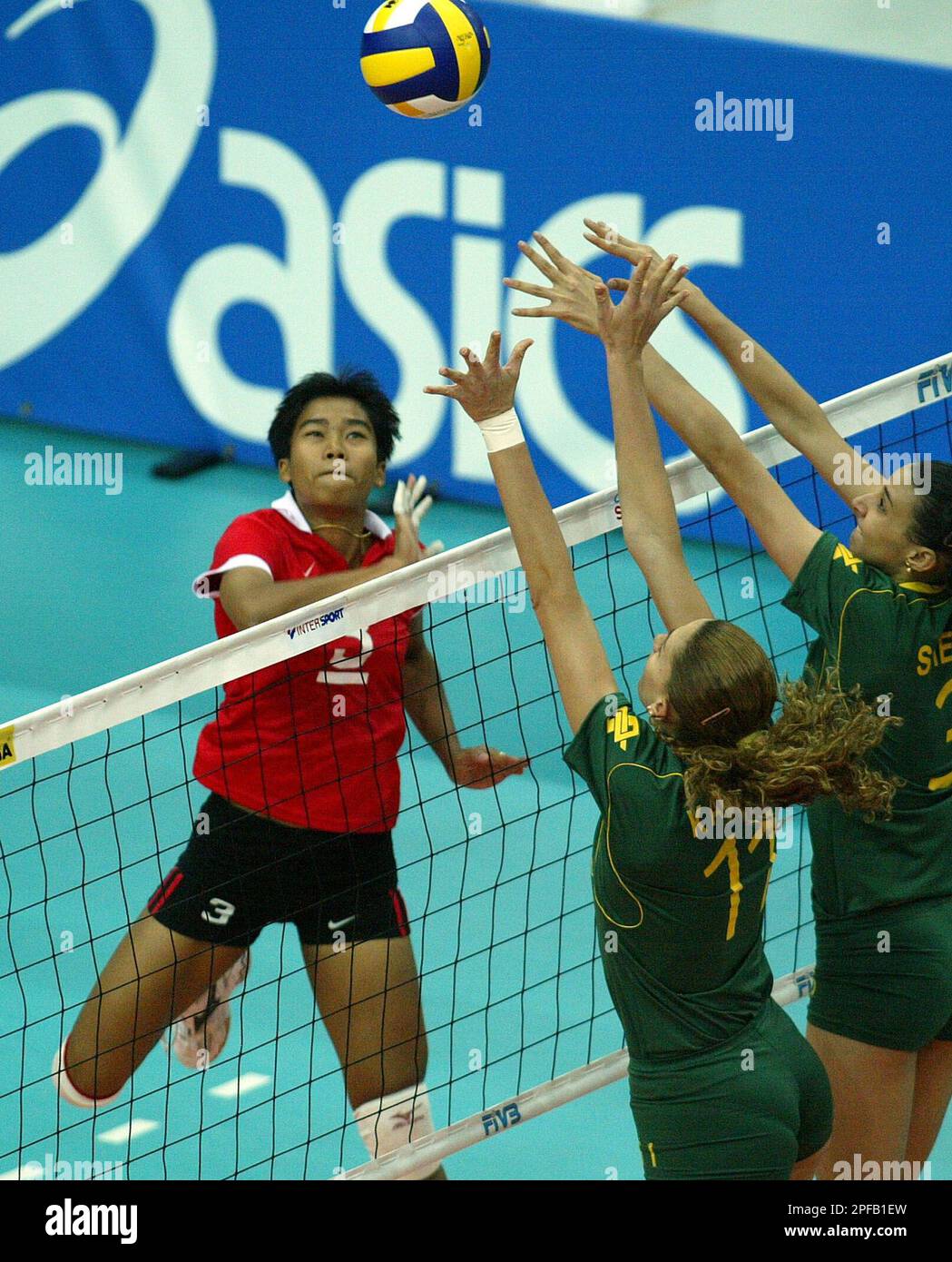 Anna Paijinda, left, of Thailand smashes a ball against Karin Rodrigues ...