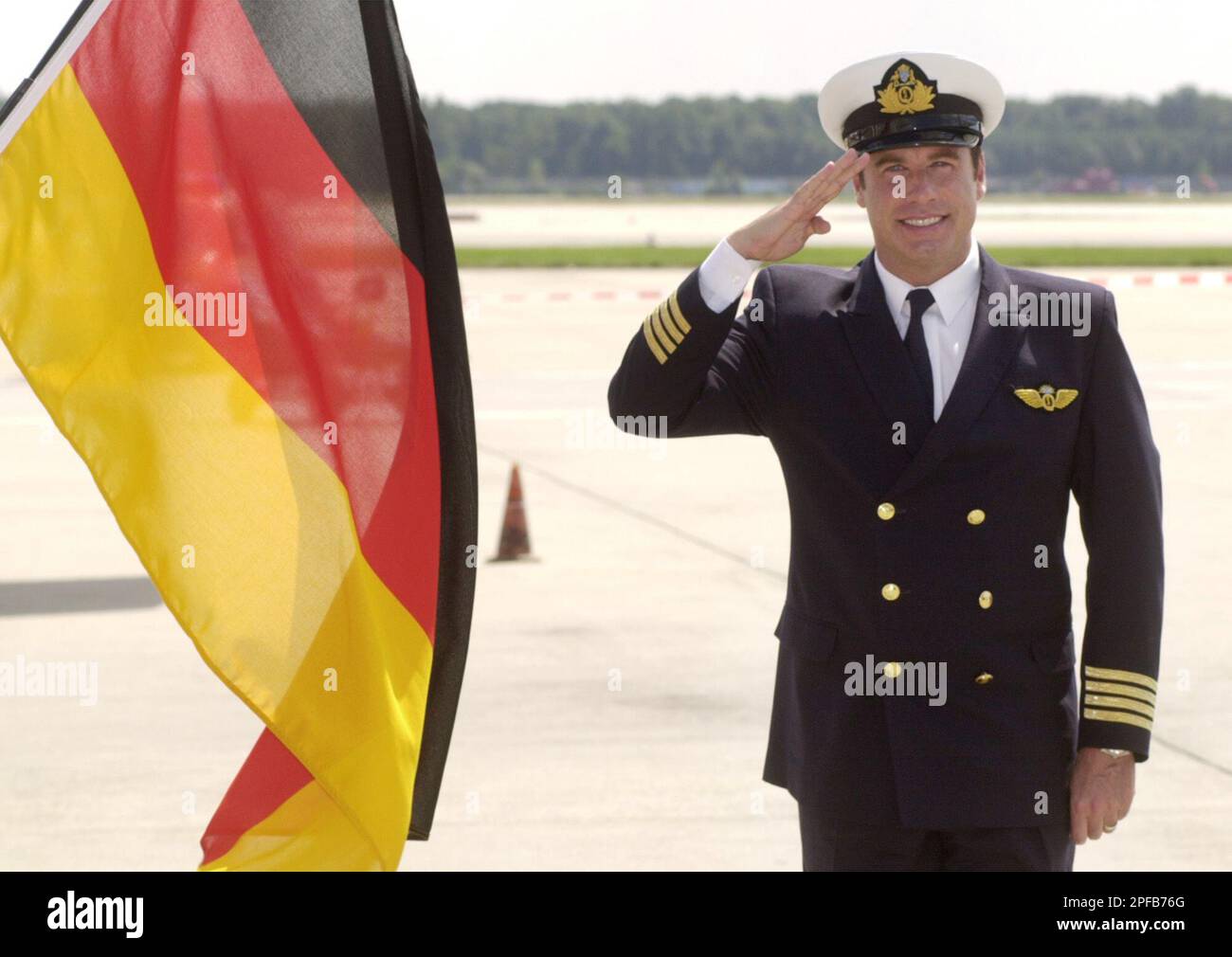 American movie star John Travolta, wearing a pilots uniform, salutes ...